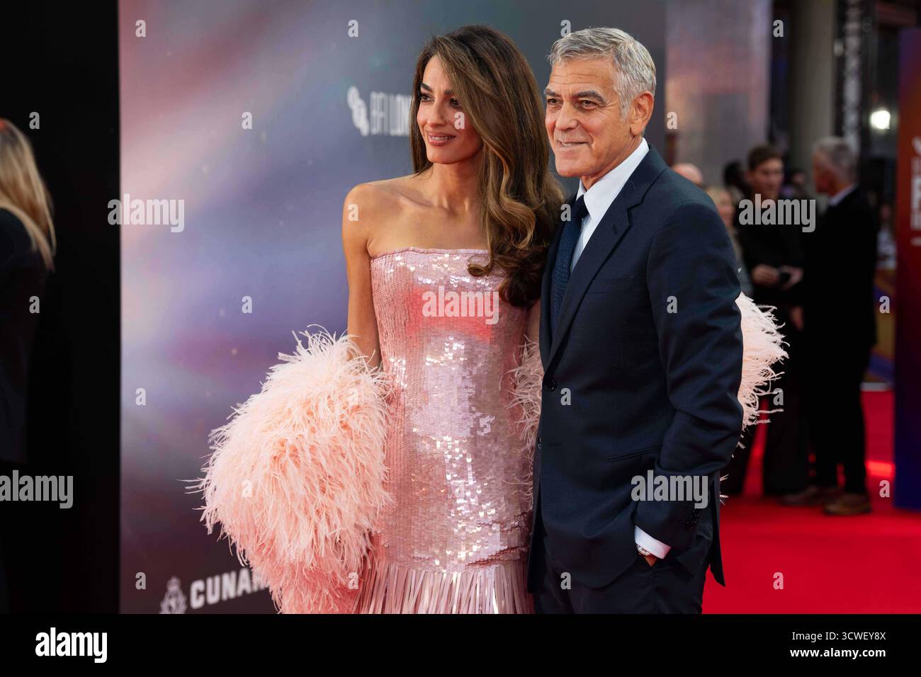 Amal Clooney, left, and George Clooney pose for photographers upon ...