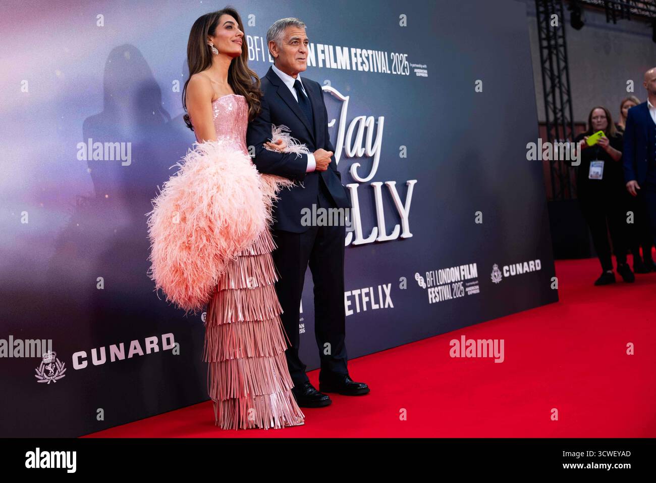 Amal Clooney, left, and George Clooney pose for photographers upon ...