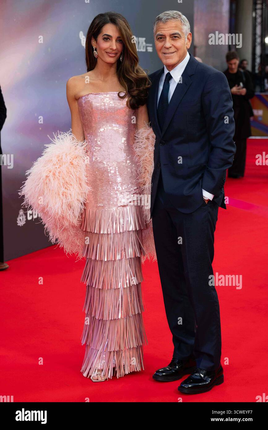 Amal Clooney, left, and George Clooney pose for photographers upon ...