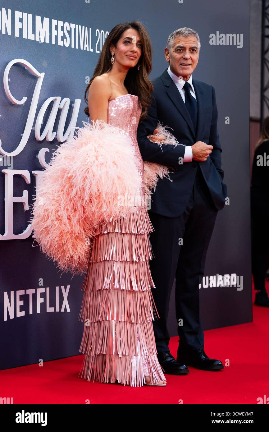 Amal Clooney, left, and George Clooney pose for photographers upon ...