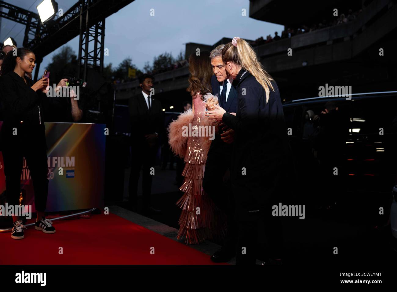 Amal Clooney, left, and George Clooney pose for photographers upon ...