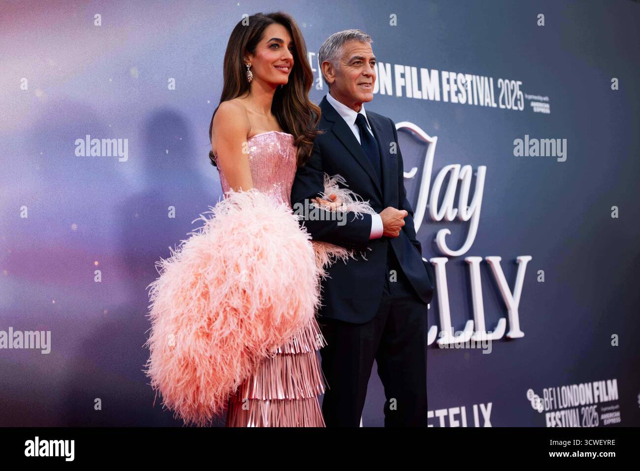 Amal Clooney, left, and George Clooney pose for photographers upon ...