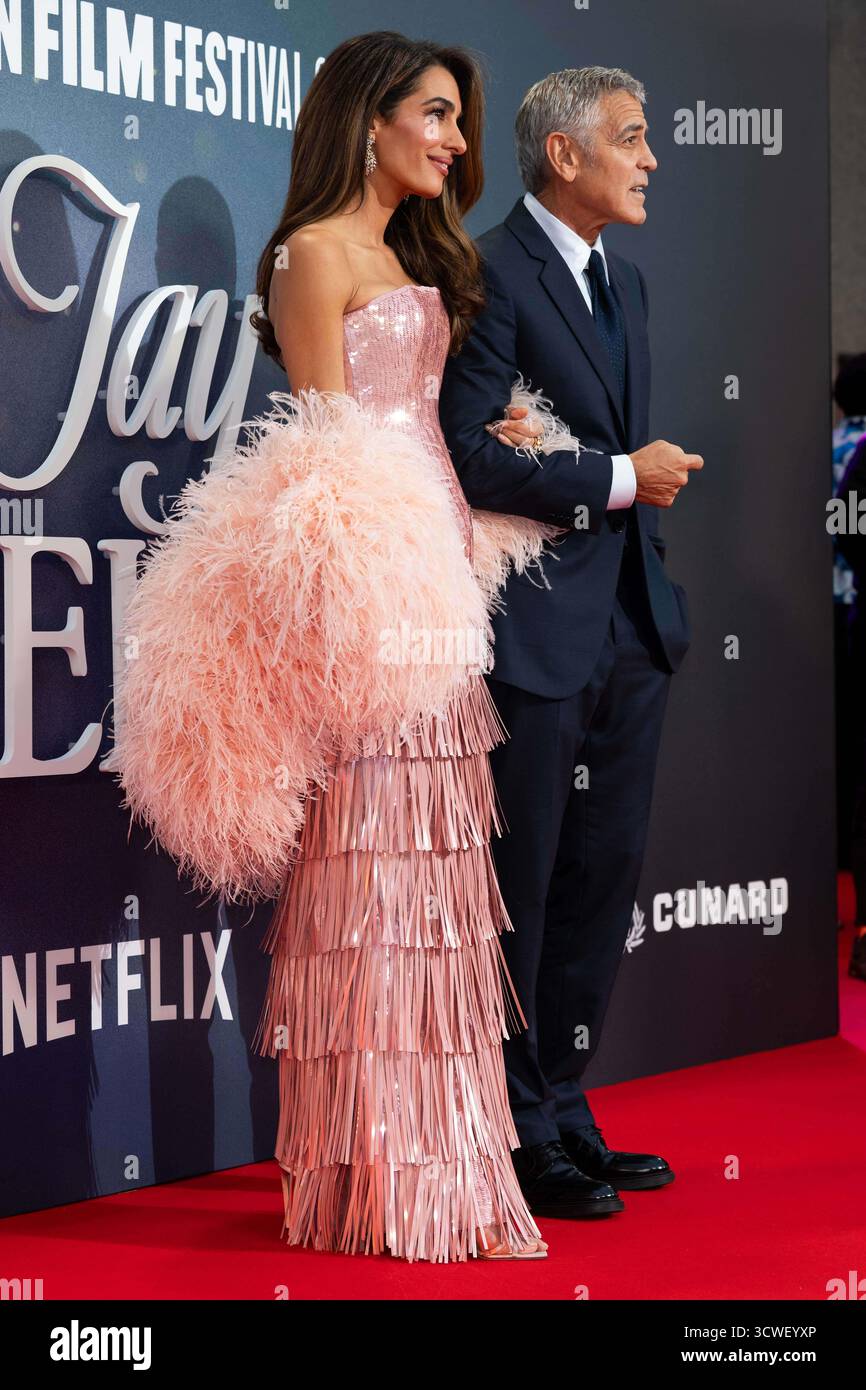 Amal Clooney, left, and George Clooney pose for photographers upon ...