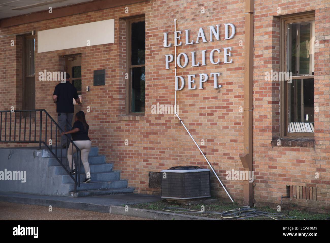Members of the Leland Police Department enter the police station in ...