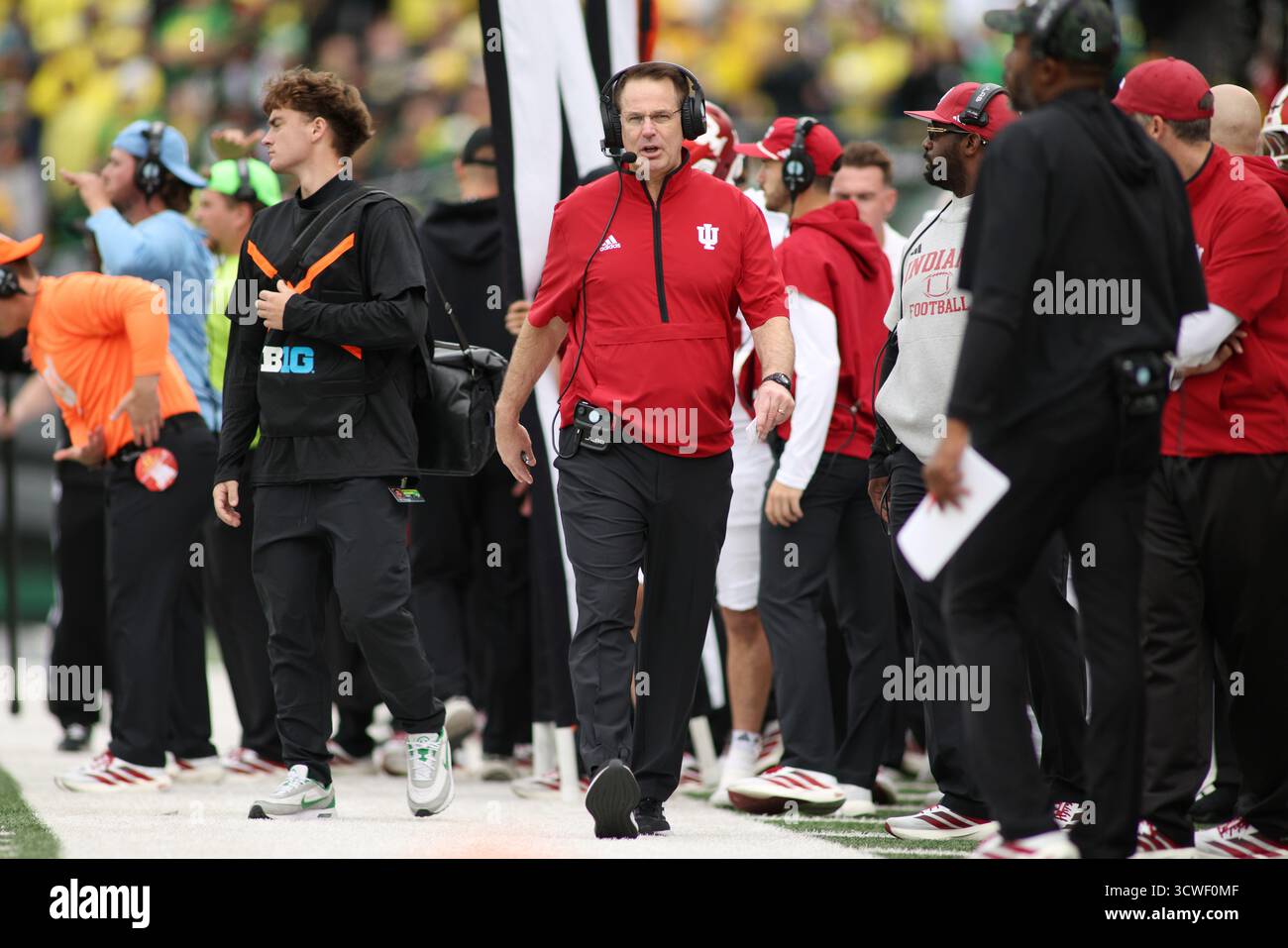 Indiana head coach Curt Cignetti, center, walks the sideline during the first half of an NCAA ...