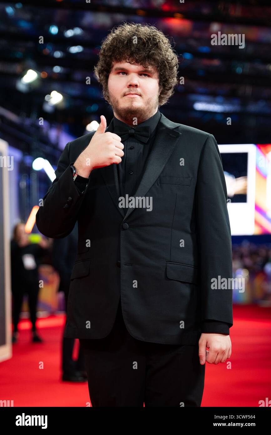 Aidan Delbis poses for photographers upon arrival at the premiere of ...