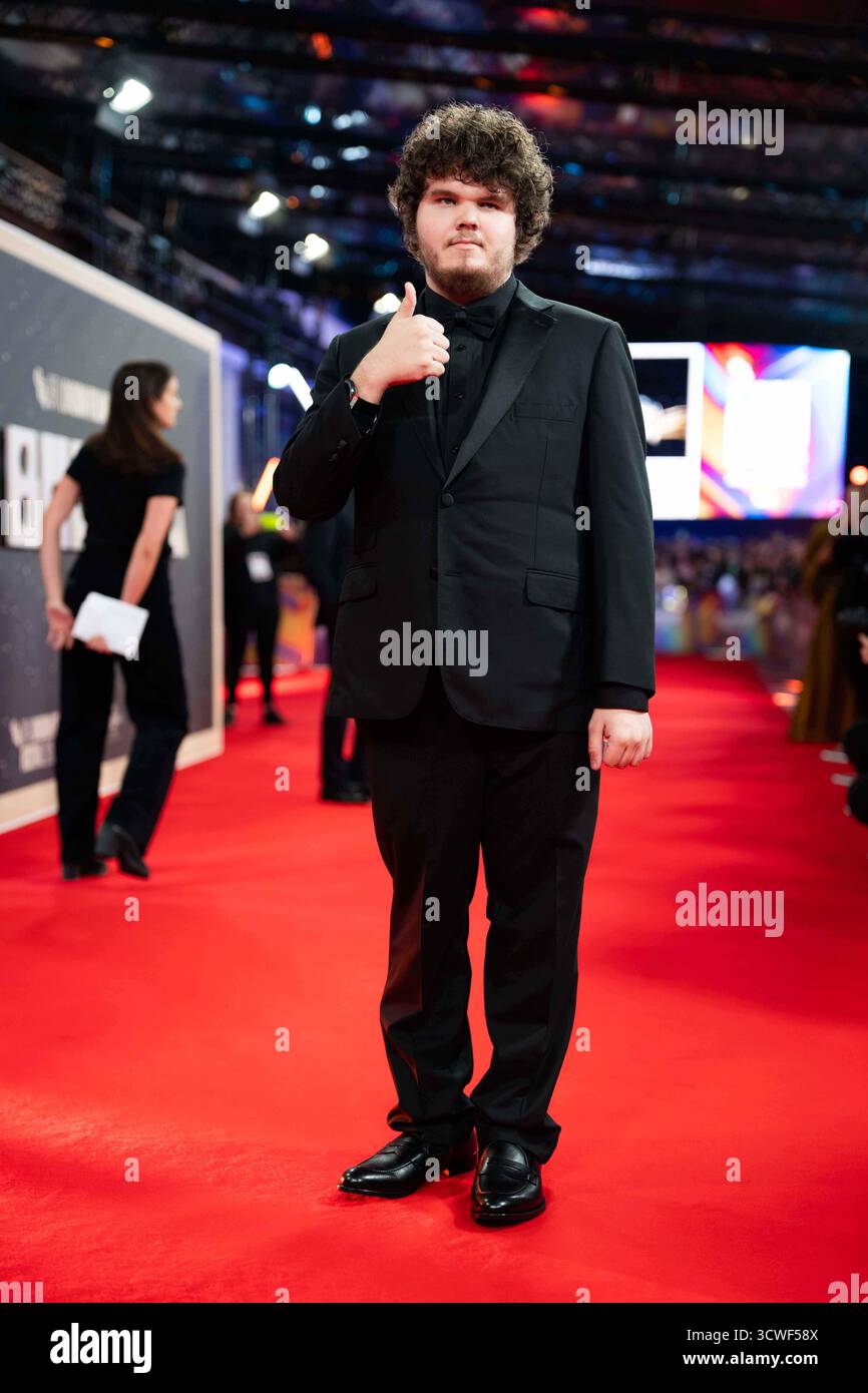 Aidan Delbis poses for photographers upon arrival at the premiere of ...