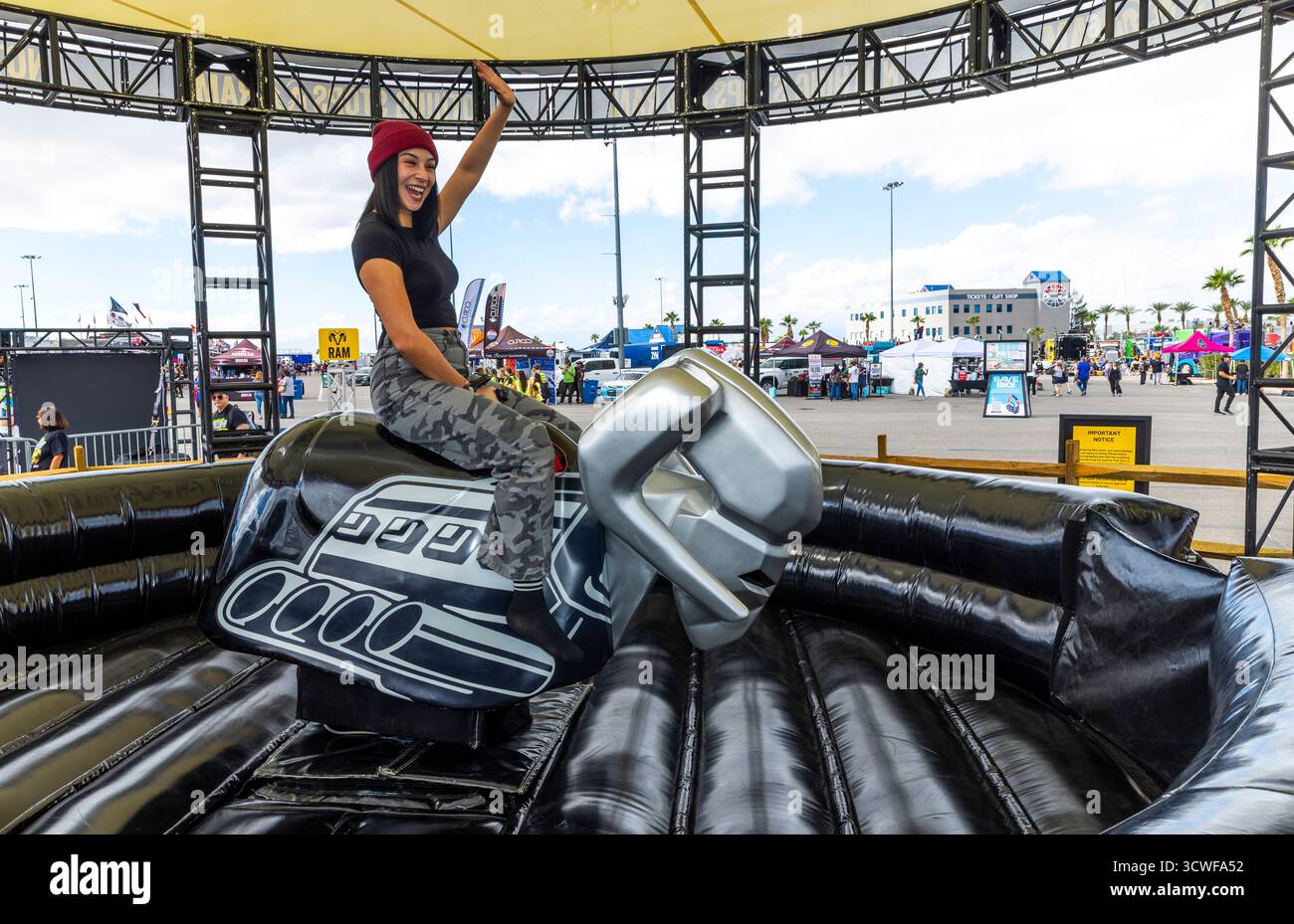 LAS VEGAS, NV - OCTOBER 11: A fan rides a mechanical RAM in the Dodge ...