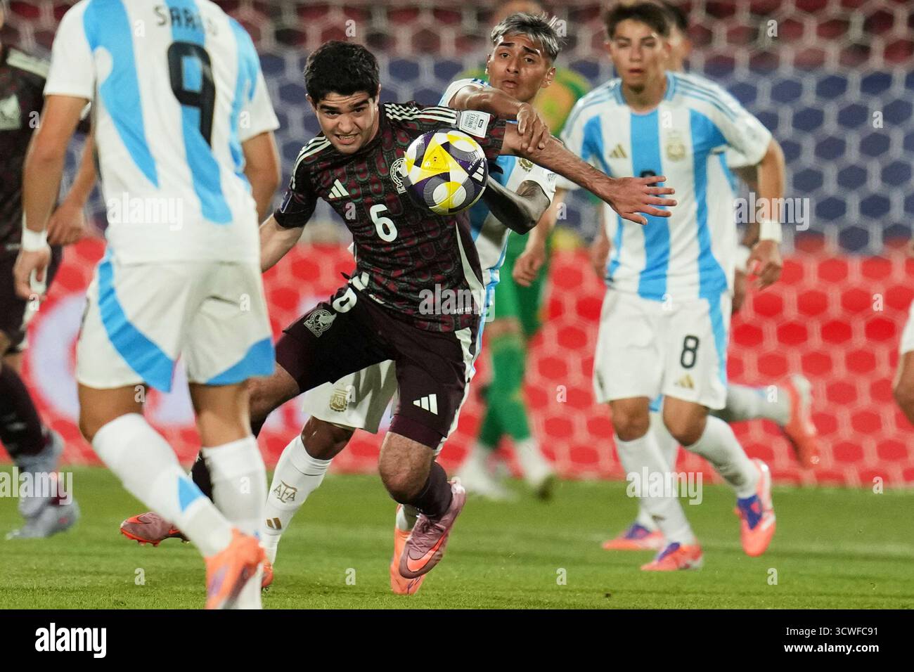 Mexico's Cesar Garza (6) and Argentina's Milton Delgado fight for the ...