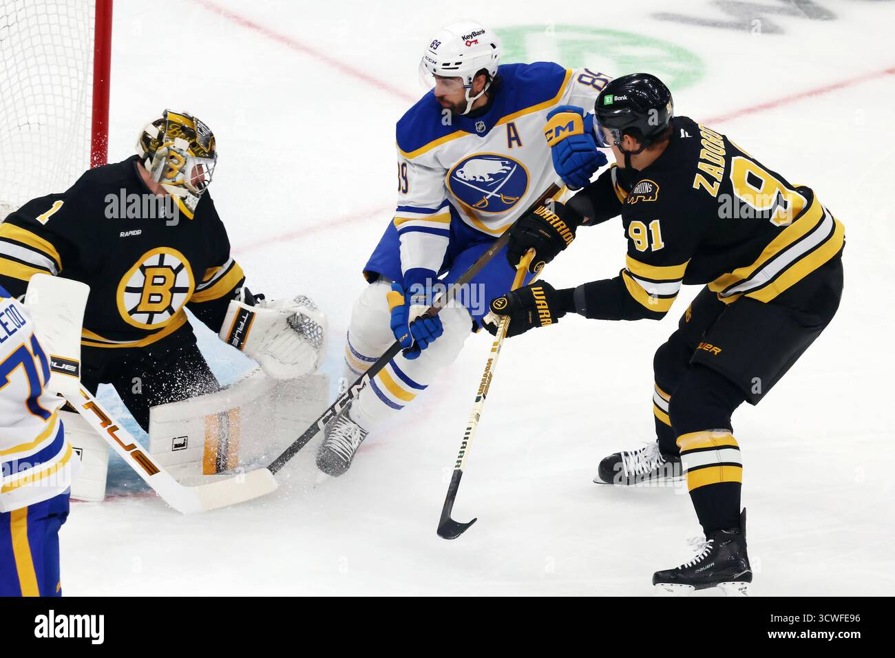Boston Bruins' Jeremy Swayman (1) blocks a shot by Buffalo Sabres' Alex ...