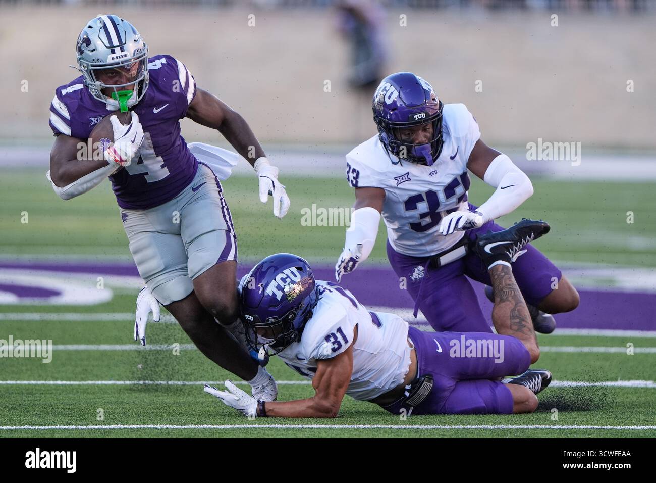 Kansas State running back Joe Jackson (4) is tackled by TCU safety ...
