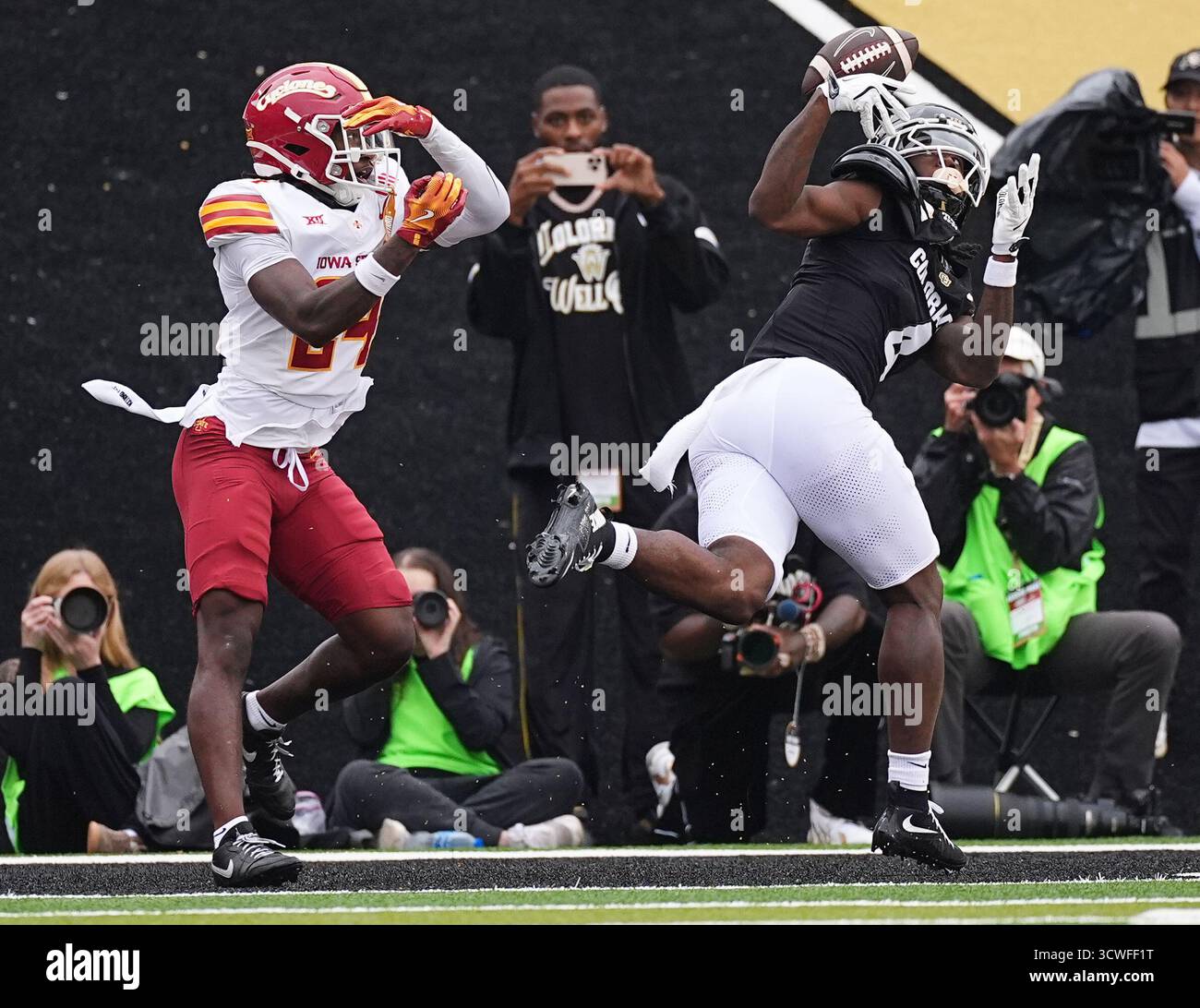 Colorado wide receiver Omarion Miller, right, misses a pass as Iowa ...