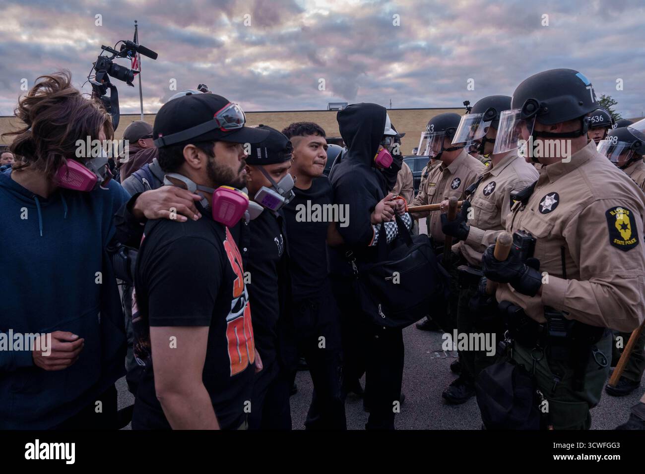 Illinois State Police move protesters back after declaring an unlawful ...
