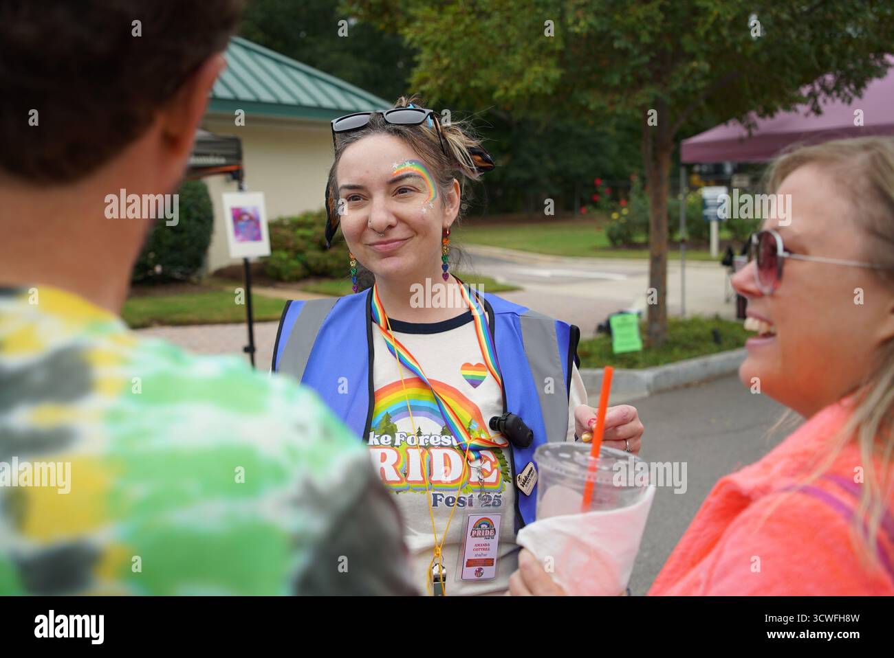 Amanda Cottrill, co-chair of Pride Fest, talks with people on the ...