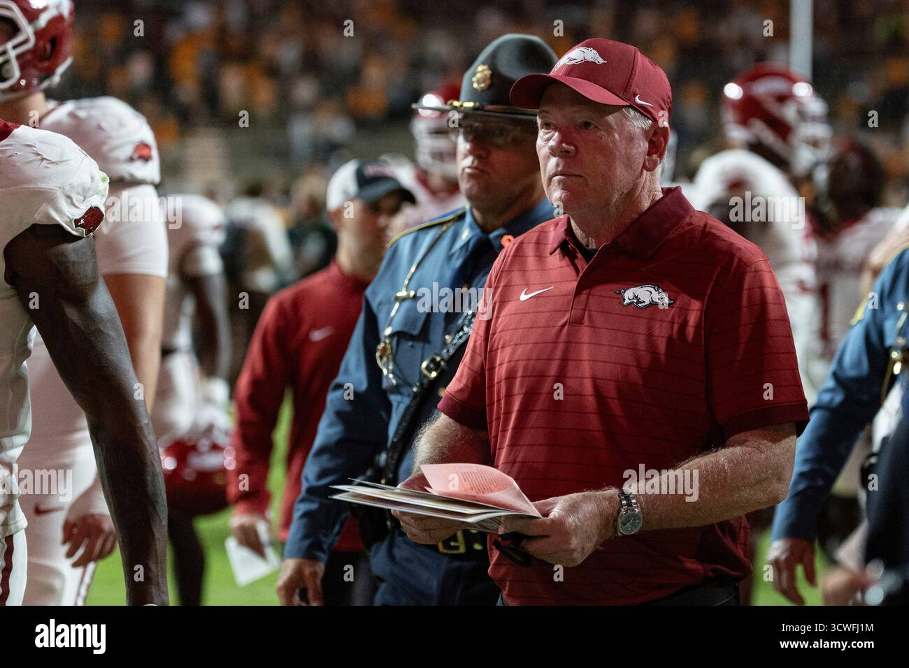 Arkansas interim head coach Bobby Petrino leaves the field after an ...