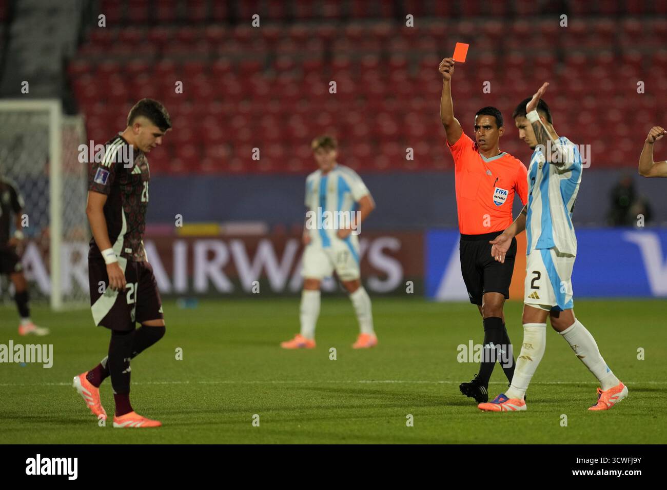 Referee Jalal Jayed shows the red card to Mexico's Tahiel Jimenez (21 ...