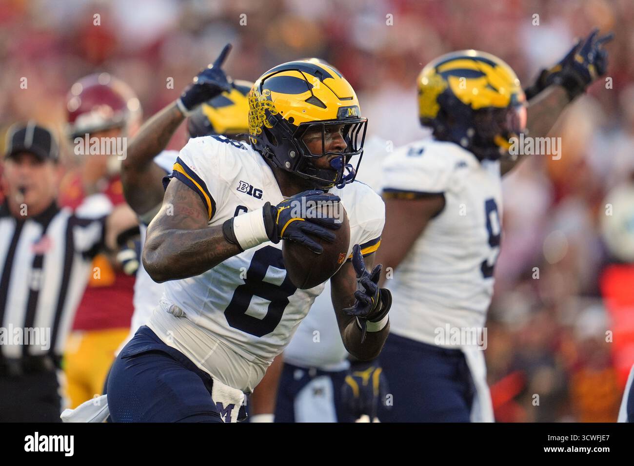 Michigan defensive end Derrick Moore (8) recovers a fumble by Southern ...
