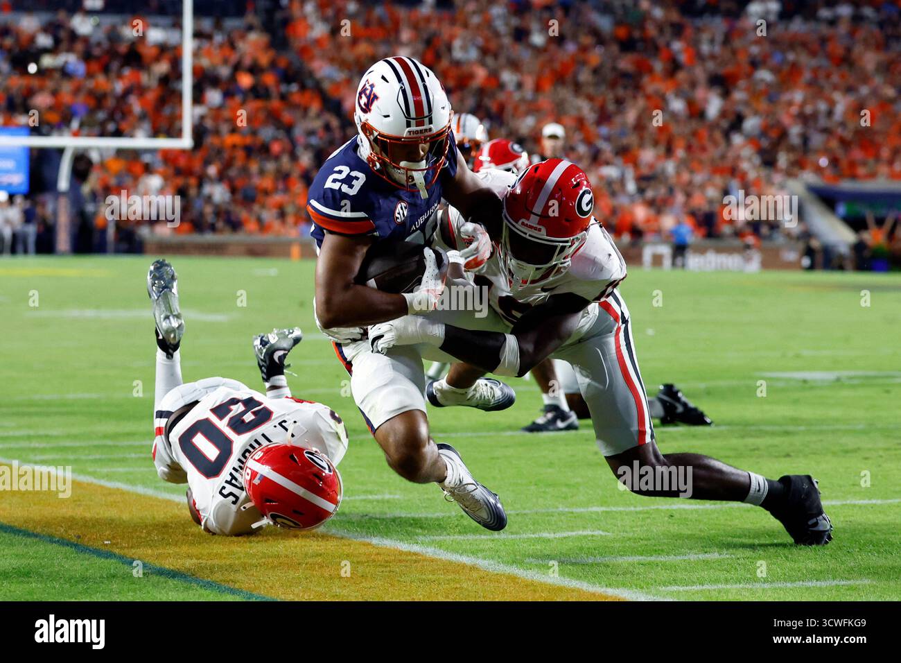 Auburn running back Jeremiah Cobb (23) is knocked out of bounds by ...