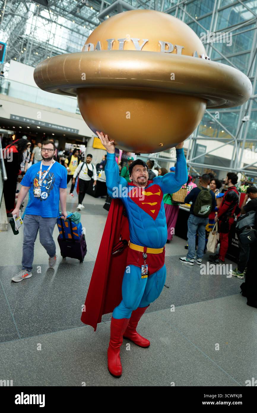 An attendee dressed as Superman poses during New York Comic Con at the ...