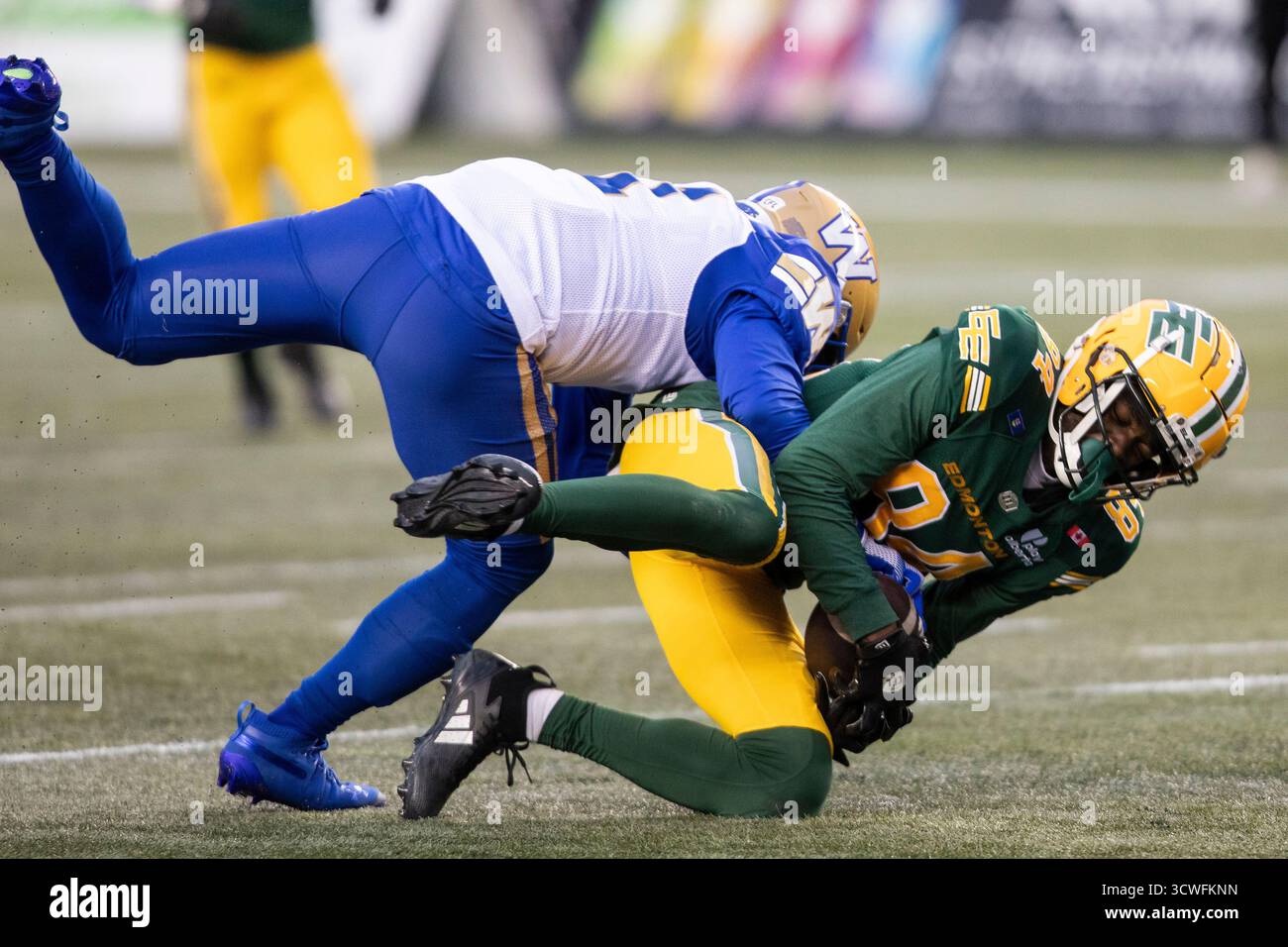 Winnipeg Blue Bombers' Jamal Parker (left) tackles Edmonton Elks' Odieu ...
