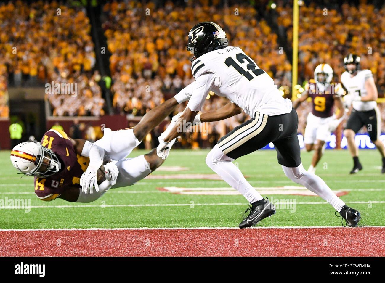 Minnesota defensive back Kerry Brown, left, intercepts a pass intended ...