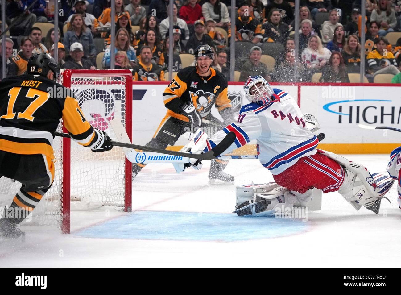 Pittsburgh Penguins' Sidney Crosby, center, and Bryan Rust (17) can't ...