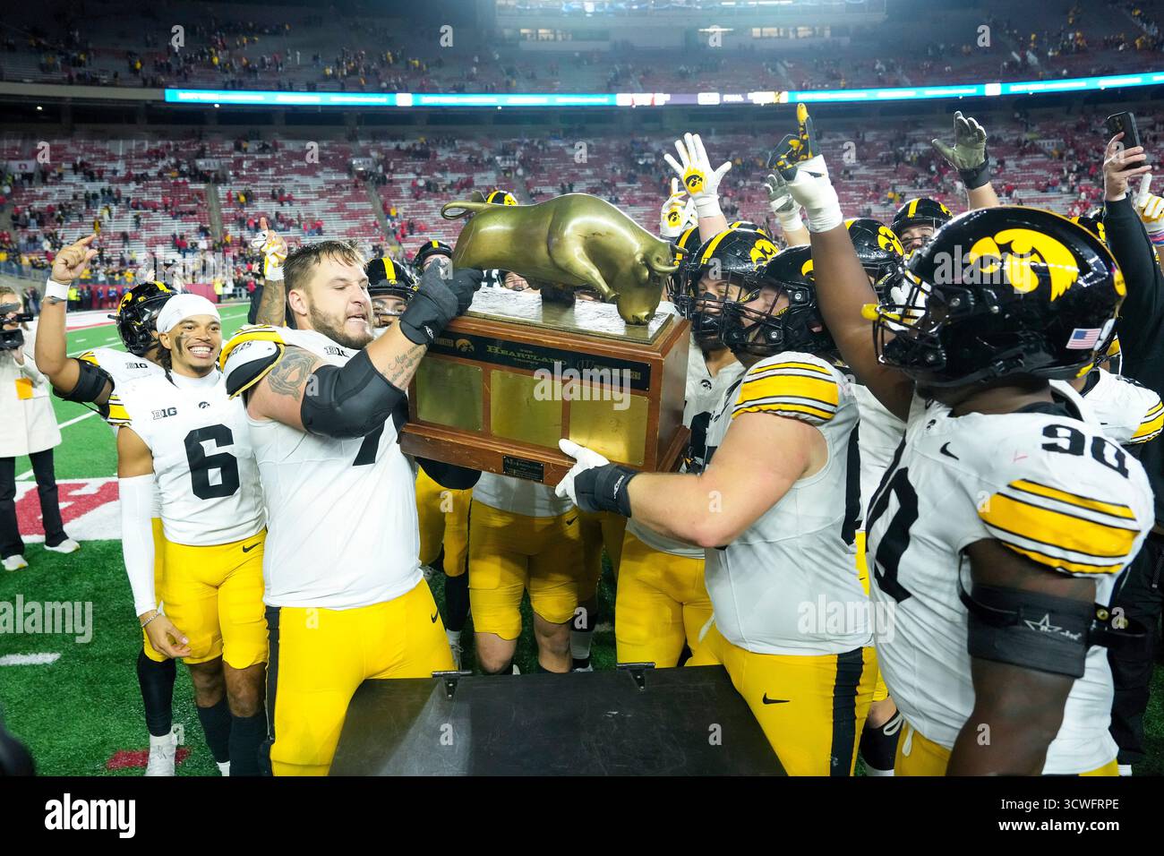 Iowa celebrates with The Heartland Trophy after beating Wisconsin in an ...