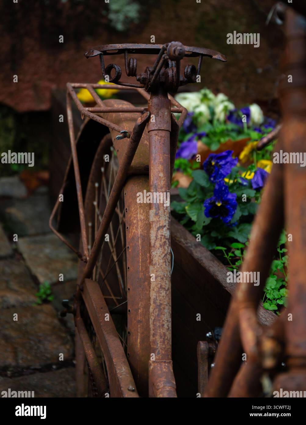 Rusty old bicycle frame with a blurred focus on its seat post and rear ...