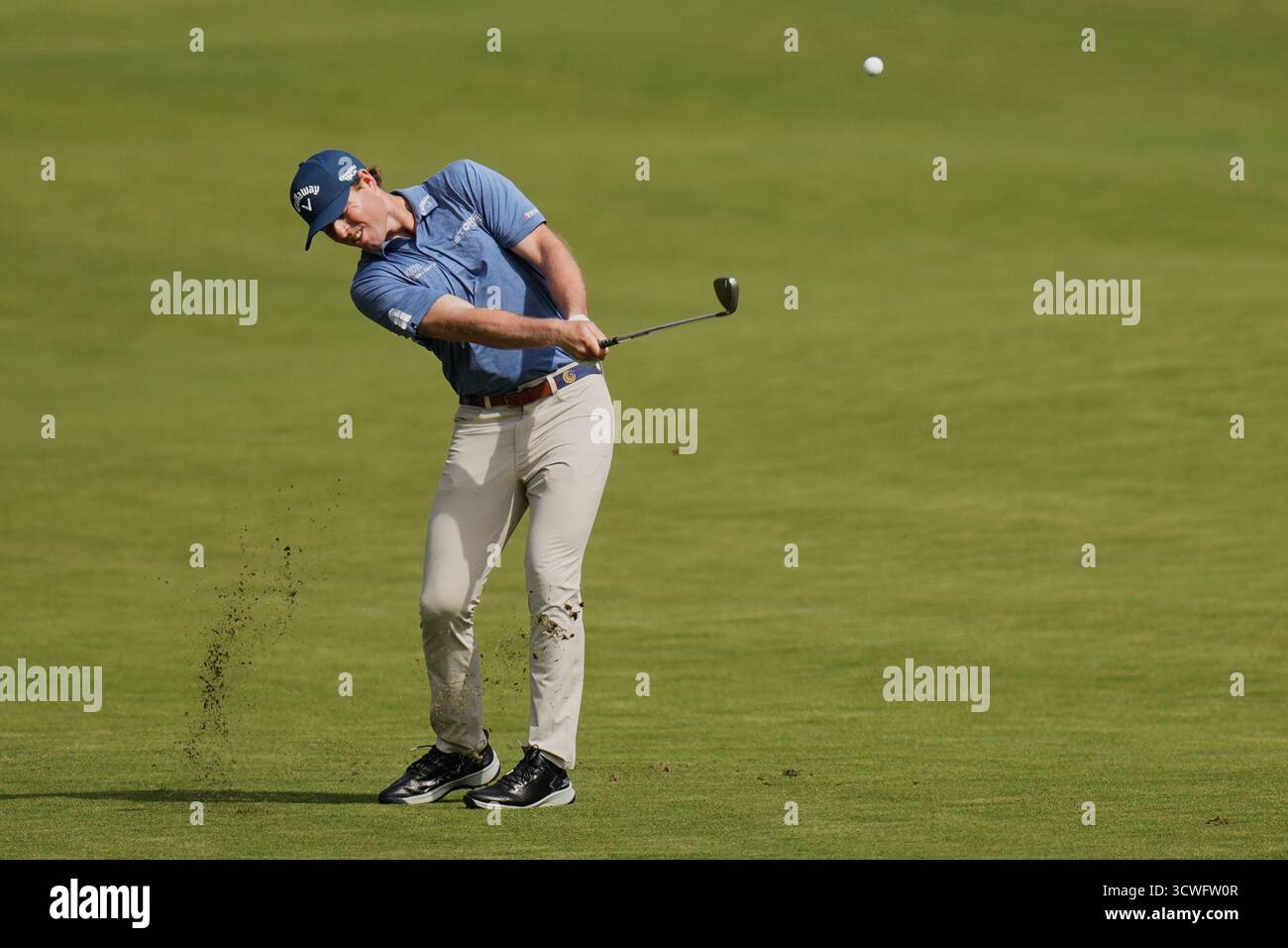 Max Greyserman, of the U.S., hits from the fairway on the first hole ...