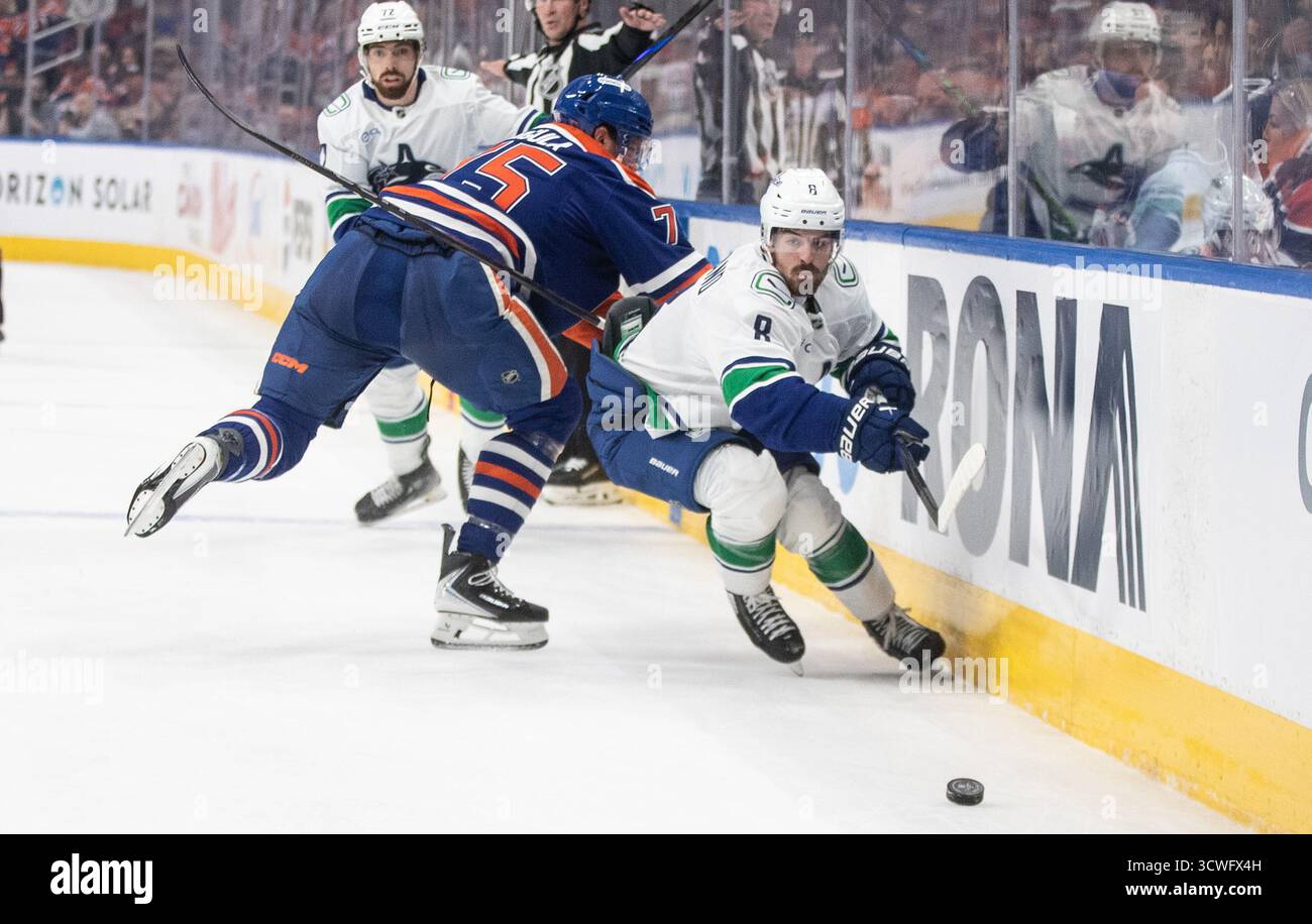 Vancouver Canucks' Conor Garland (8) escapes a hit by Edmonton Oilers ...