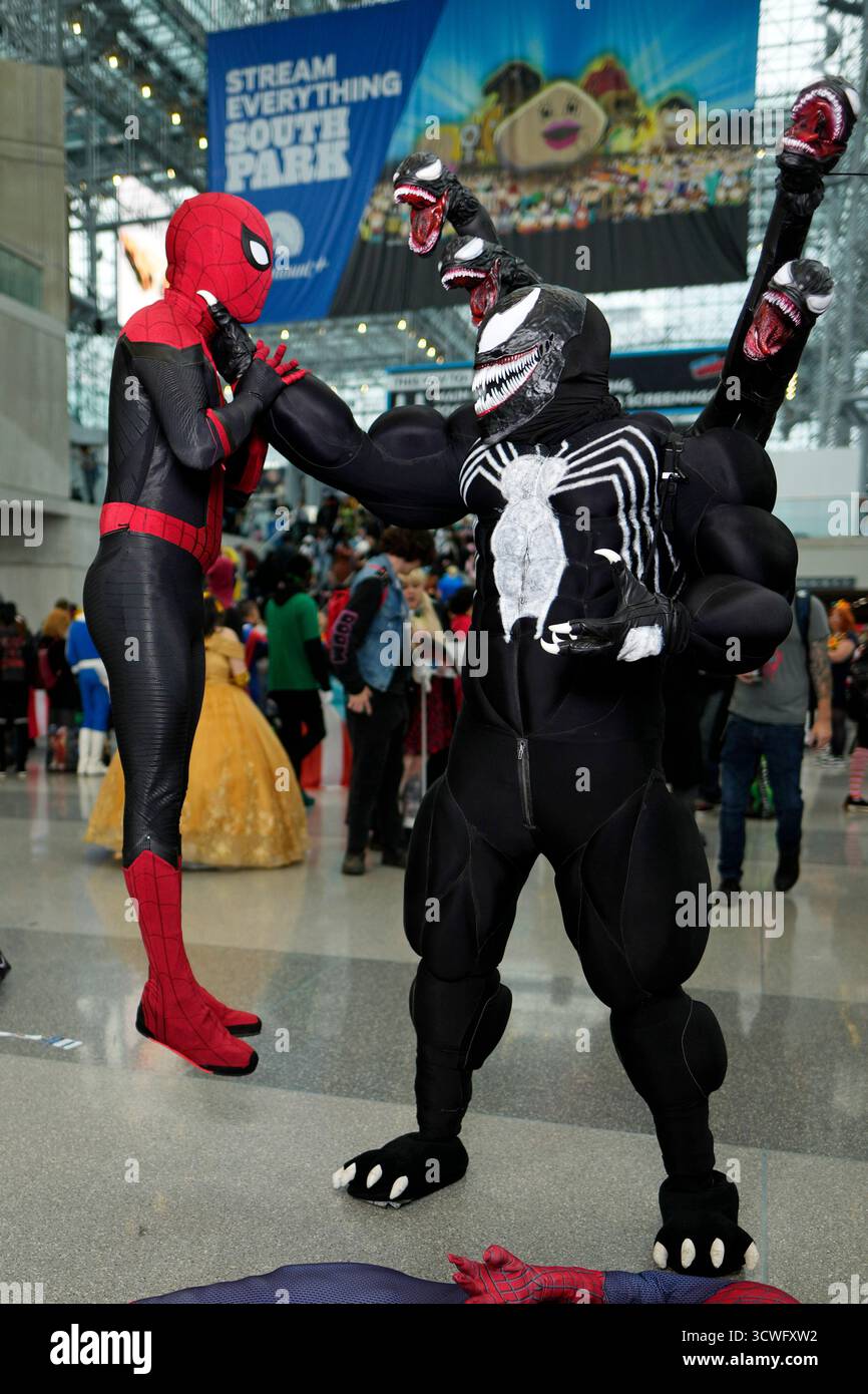 Attendees dressed as Spider-Man characters mock fight during New York ...