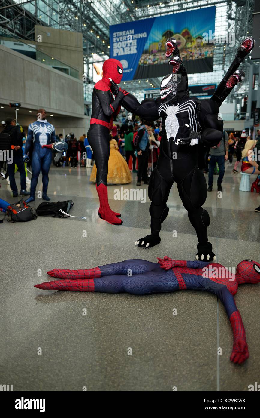Attendees dressed as Spider-Man characters mock fight during New York ...