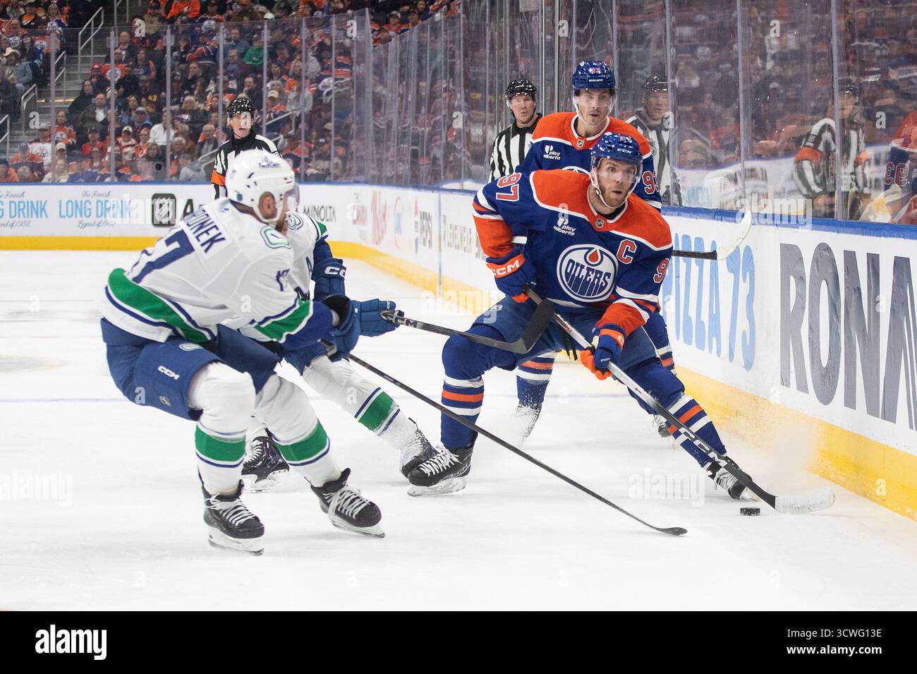 Vancouver Canucks' Filip Hronek (17) chases Edmonton Oilers' Connor ...