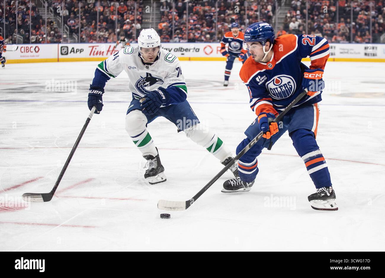 Vancouver Canucks' Jake DeBrusk (74) chases Edmonton Oilers' Matt ...