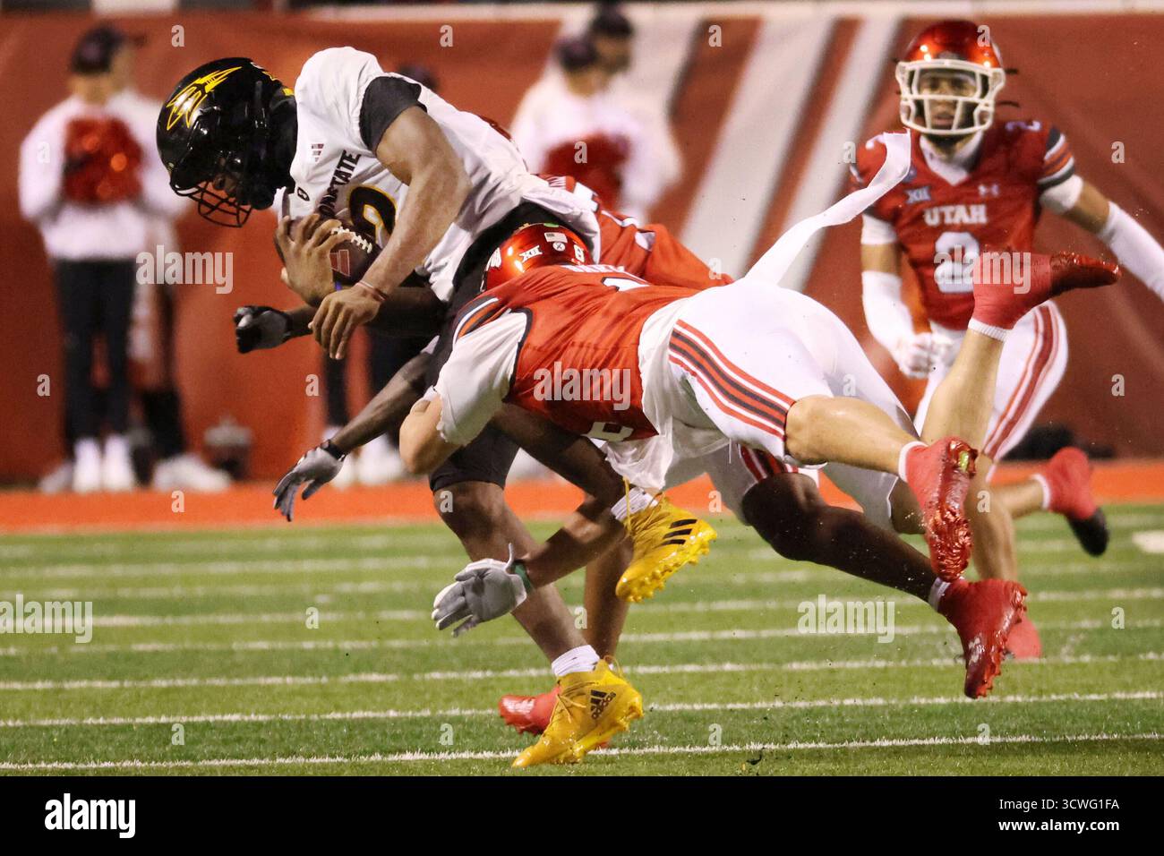 Arizona quarterback Jeff Sims, left, is tackled by Utah linebacker ...