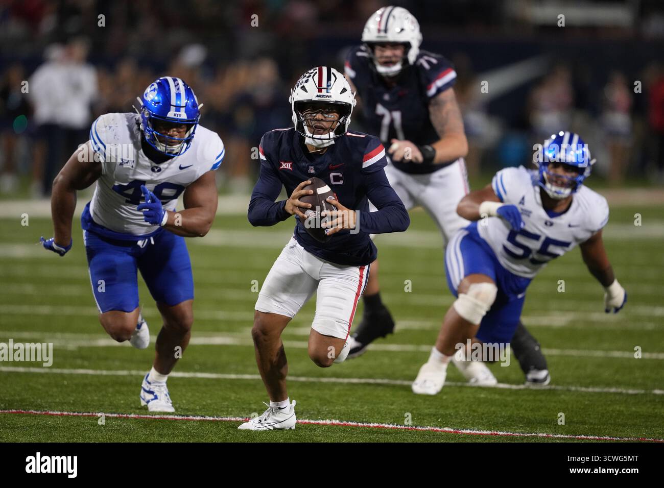 Arizona quarterback Noah Fifita runs away from BYU linebacker Bodie ...