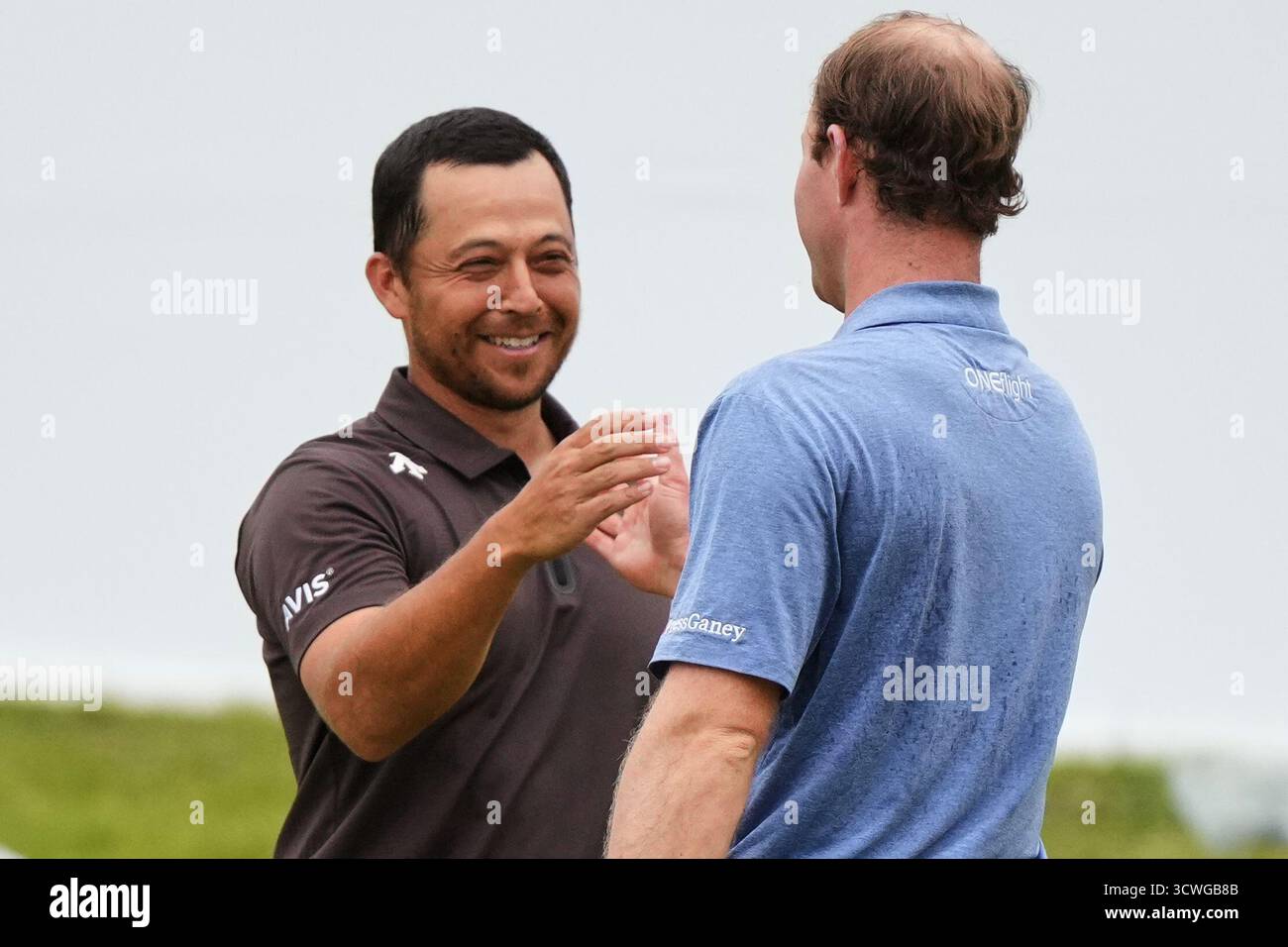 Xander Schauﬀele, left, of the U.S., shakes hands with Max Greyserman ...