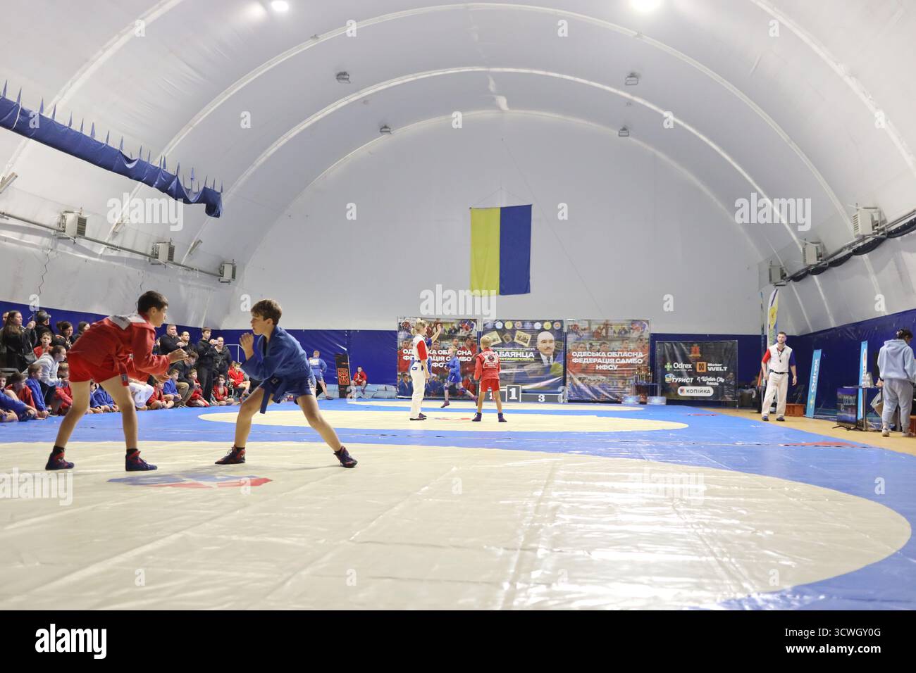 Sambist Pavel Groza in a red uniform in action during the competition ...