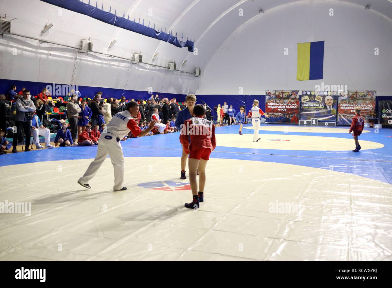 Sambist Pavel Groza in a red uniform in action during the competition ...