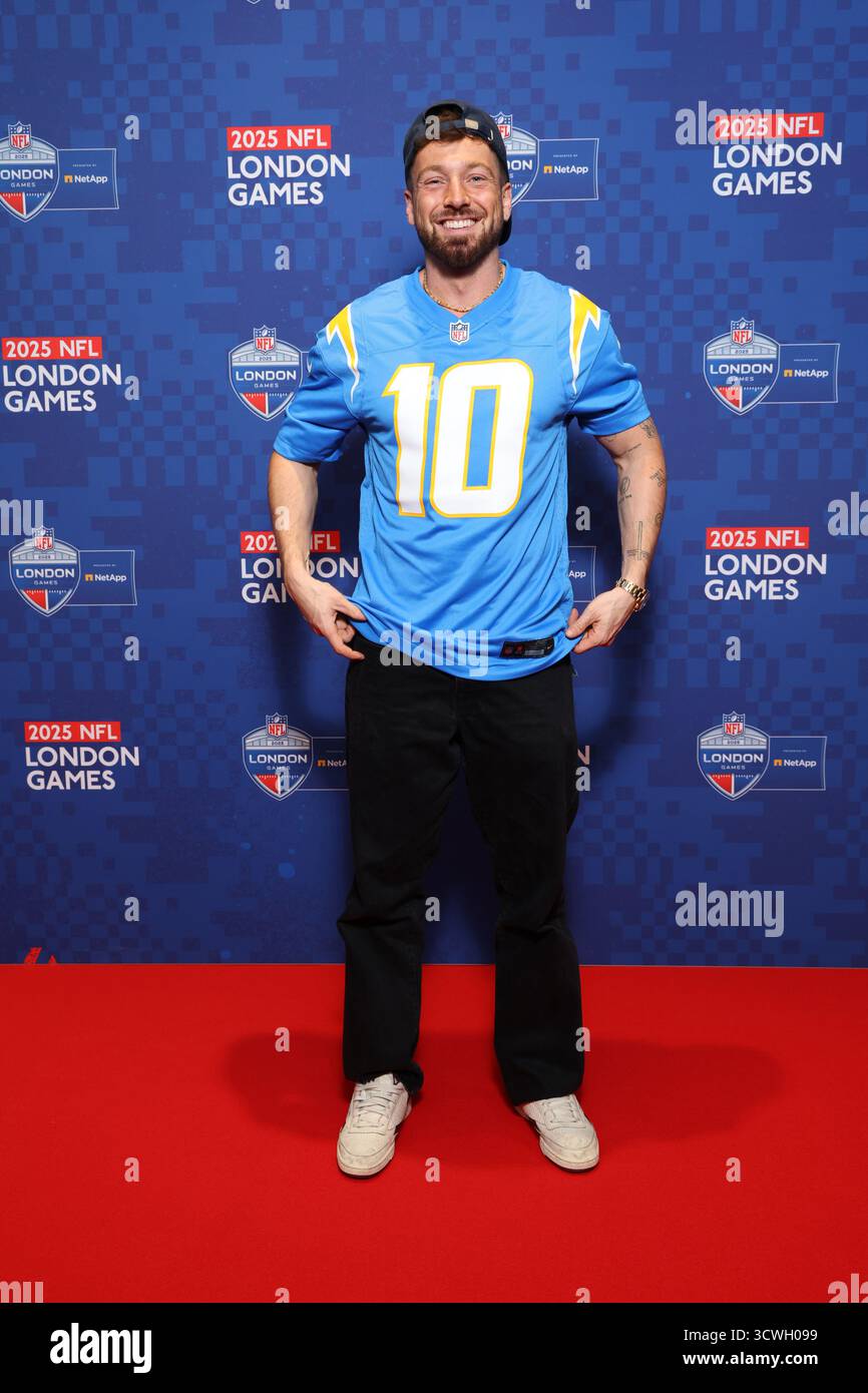 Sam Thompson walks the red carpet before an NFL football game between ...
