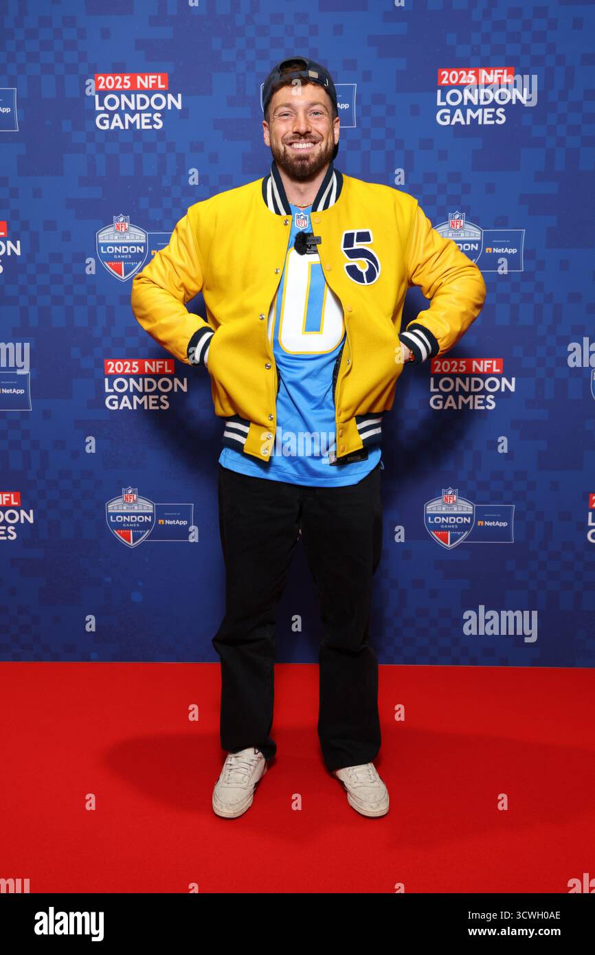 Sam Thompson walks the red carpet before an NFL football game between ...