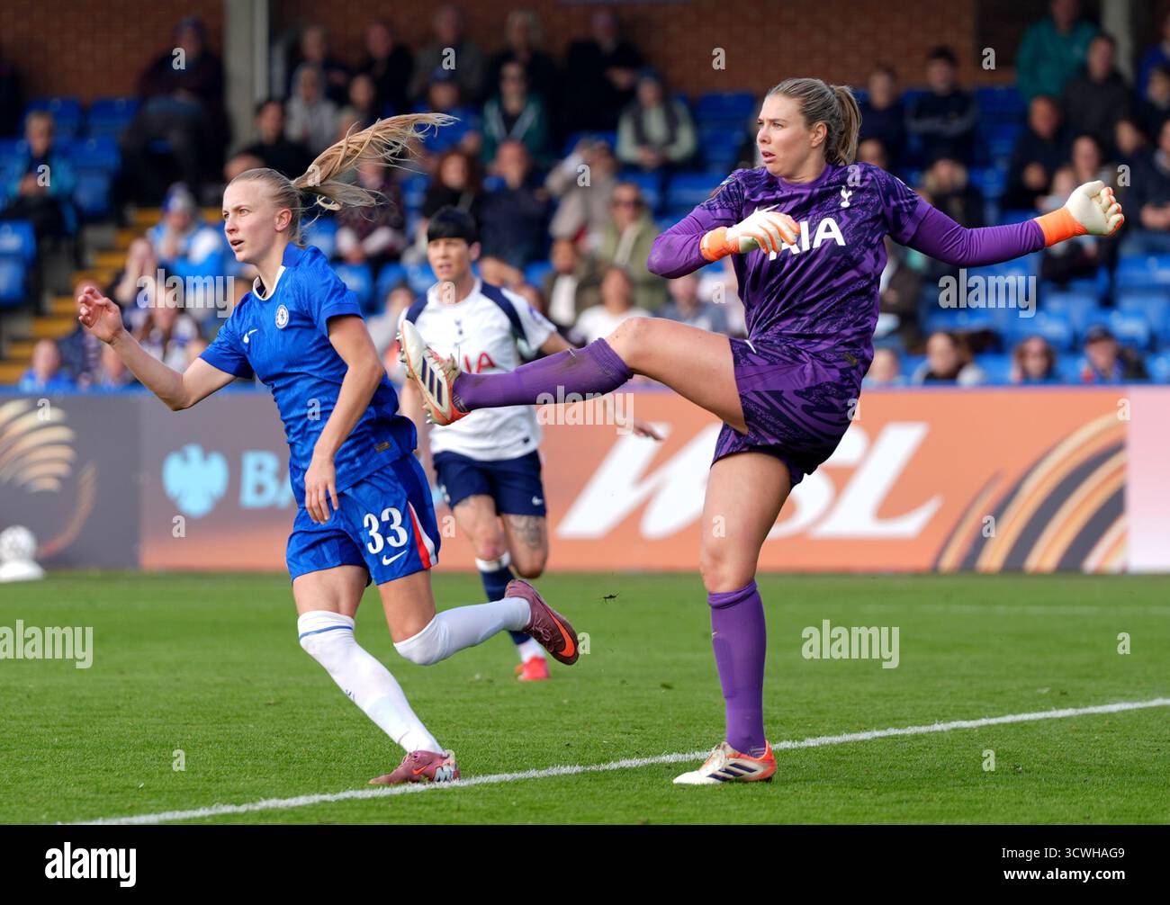 Tottenham Hotspur goalkeeper Lize Kop (right) clears the ball under ...