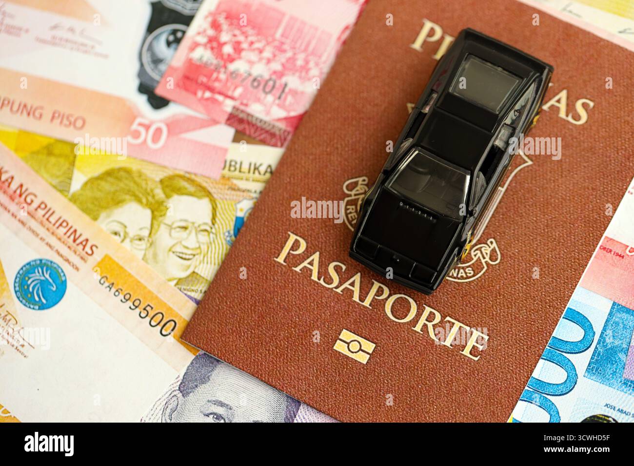 Philippines peso currency money bills and car with passport close up ...