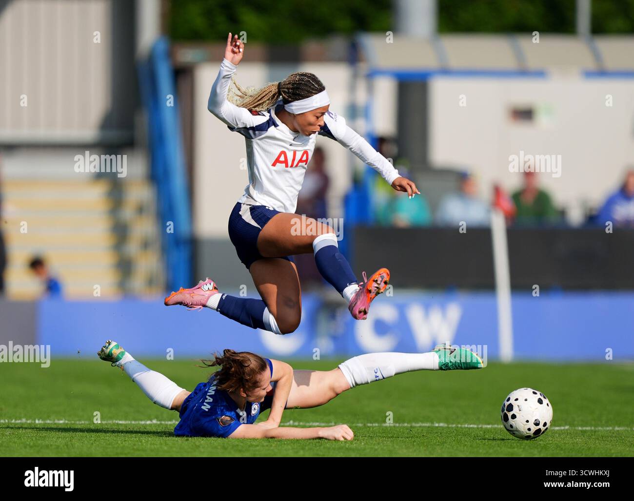 Tottenham Hotspur's Lenna Gunning-Williams (top) jumps over Chelsea's ...