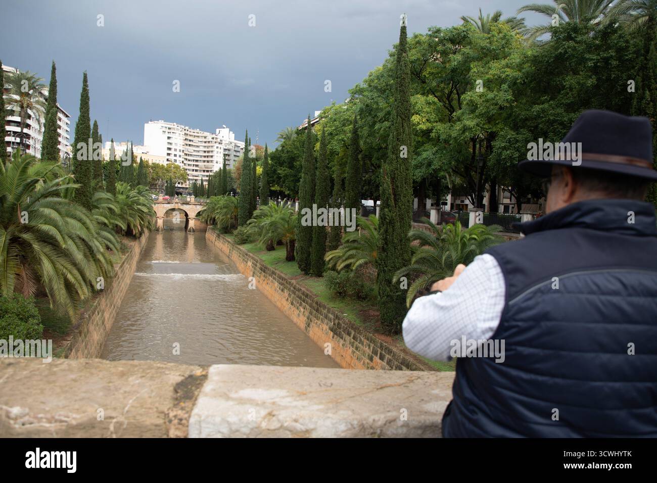 12 October 2025, Spain, Palma: A man looks out over the Sa Riera ...