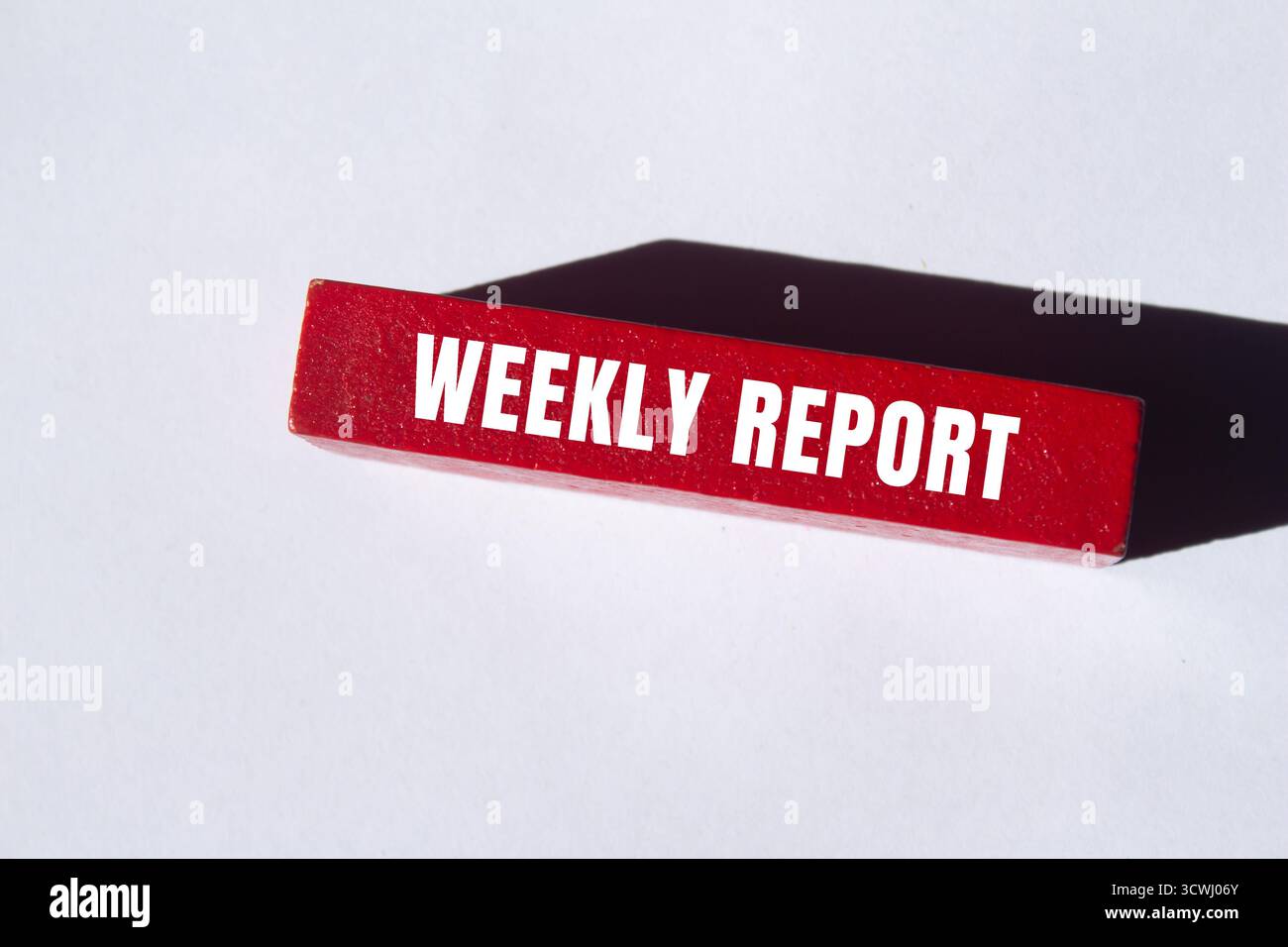 Weekly report message written on wooden block background. Conceptual ...