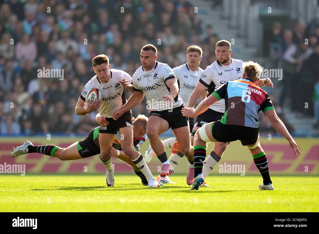 Harlequins' Jack Walker (left) tackles Saracens' Fergus Burke during ...