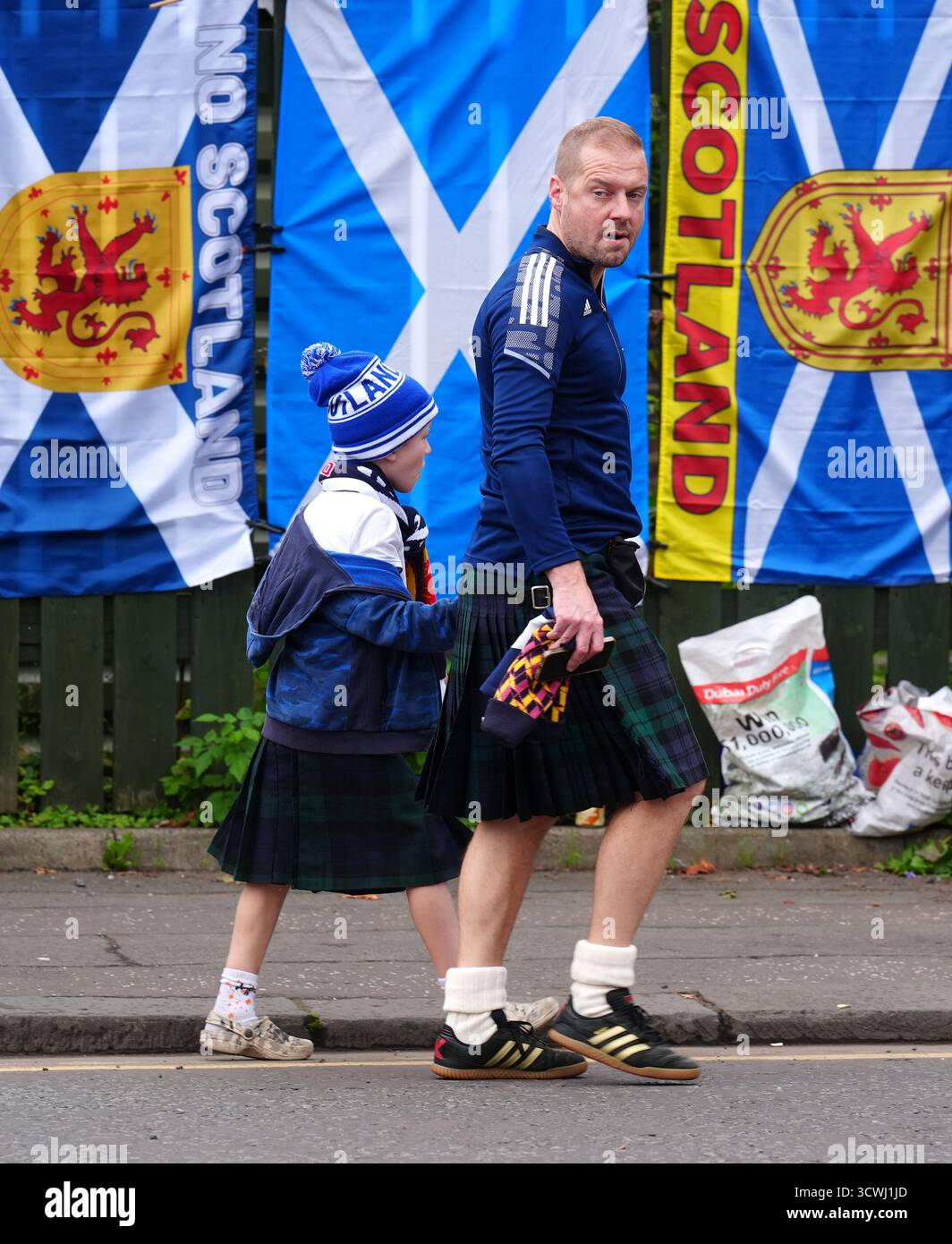 Scotland fans wearing kilts make their way to the stadium ahead of the ...