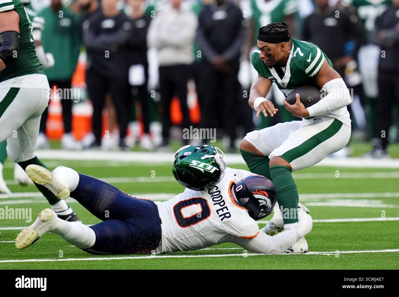 New York Jets' Justin Fields (right) is sacked by the Denver Broncos ...