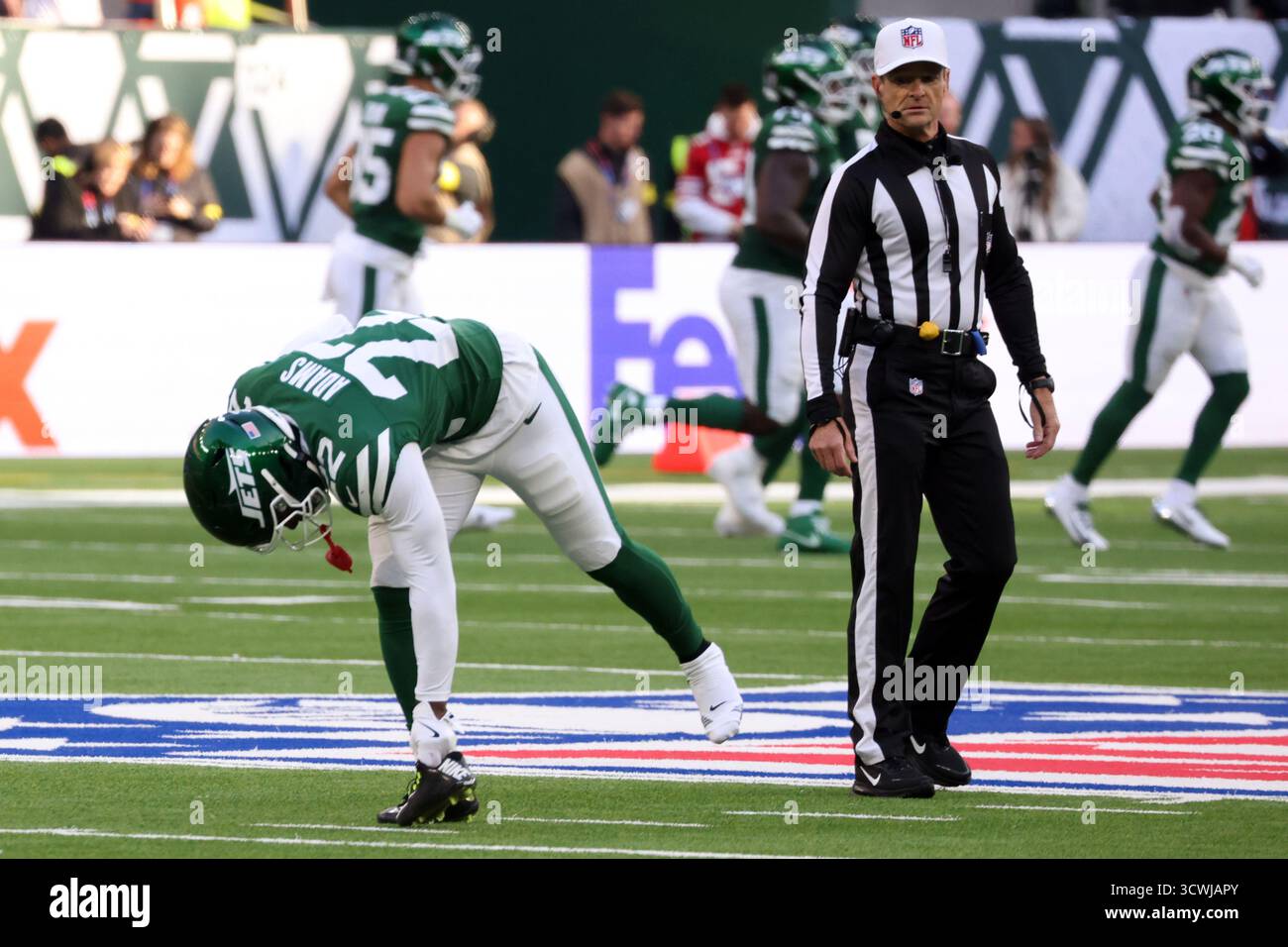 New York Jets safety Tony Adams (22) picks up his shoe after a play ...
